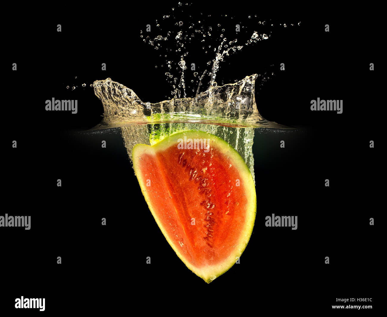 Fresh melon falling in water with splash on black Stock Photo - Alamy