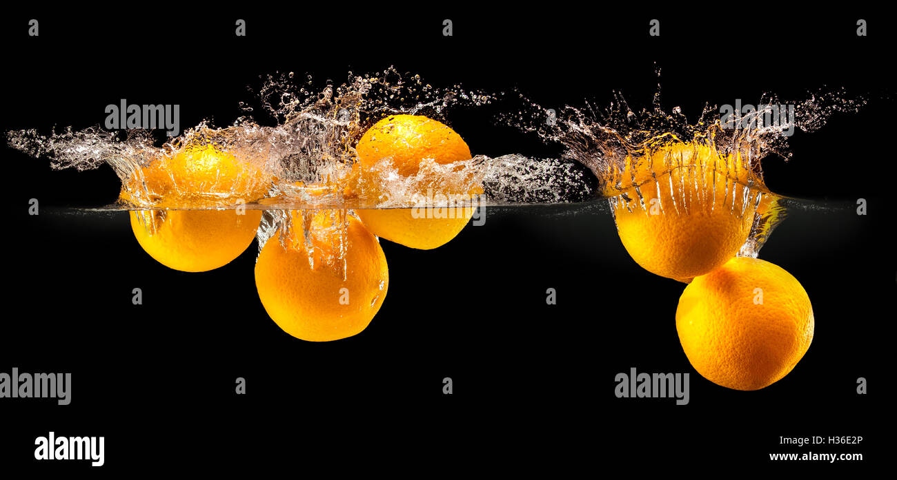 Group of fresh fruits falling in water on black Stock Photo - Alamy
