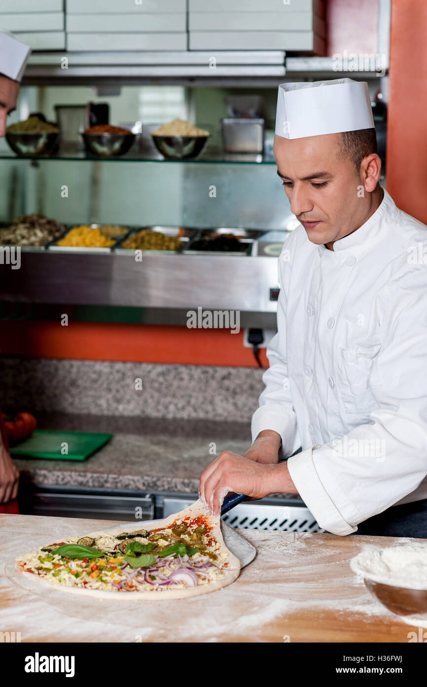 Chef busy in preparing pizza Stock Photo - Alamy