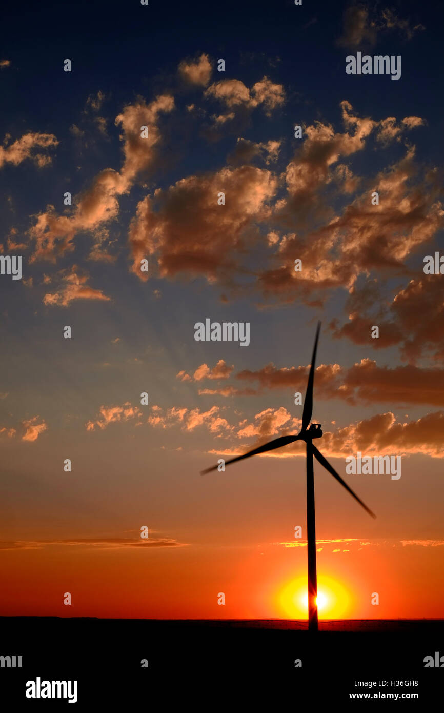 Windmill with sunset and clouds generating electricity and sustainable ...