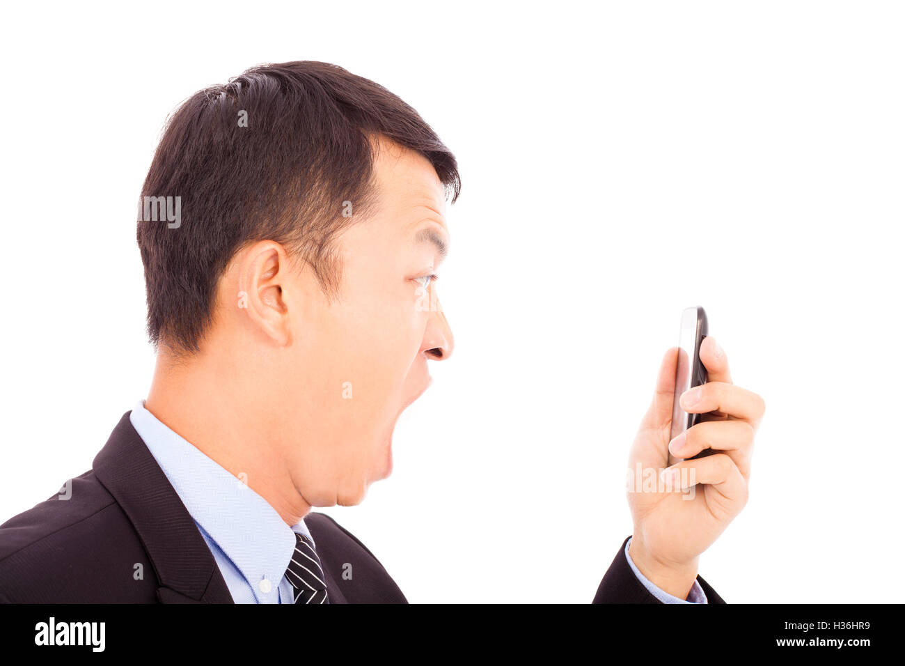 businessman screaming into smart phone over white background Stock ...