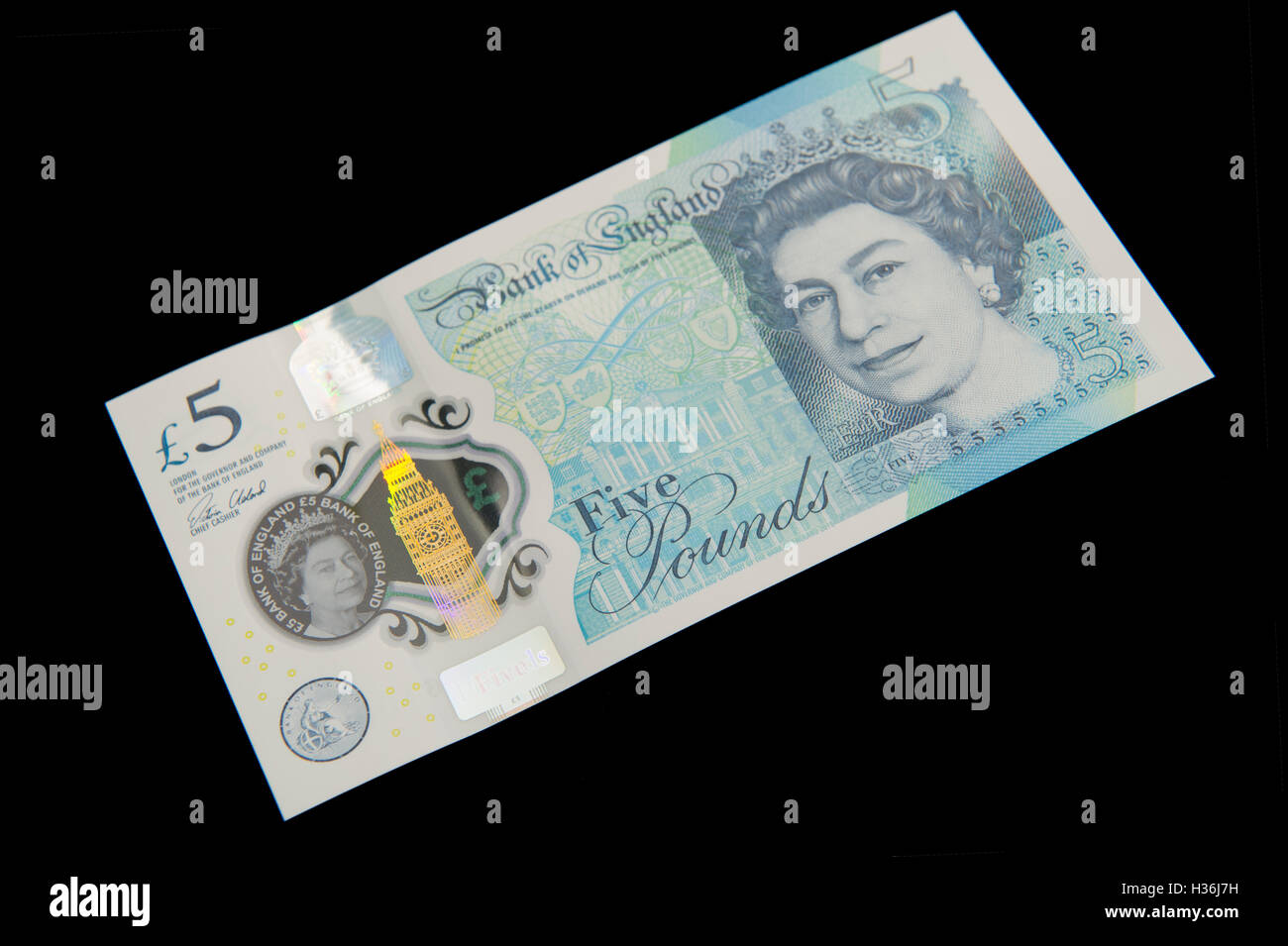 Front view of the new plastic (polymer) five pound note on a black ...