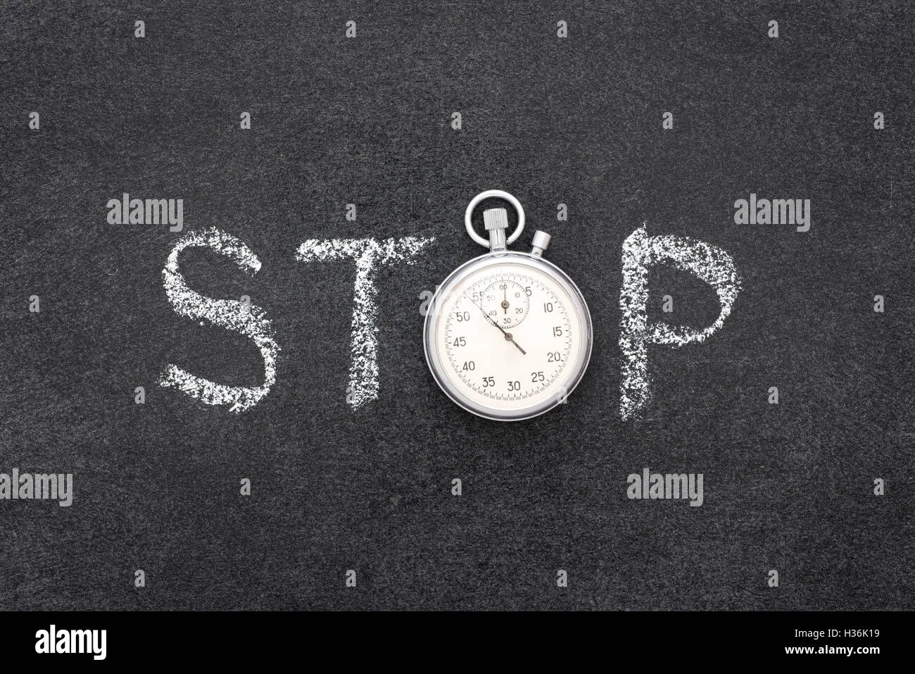 stop word handwritten on chalkboard with vintage precise stopwatch used ...