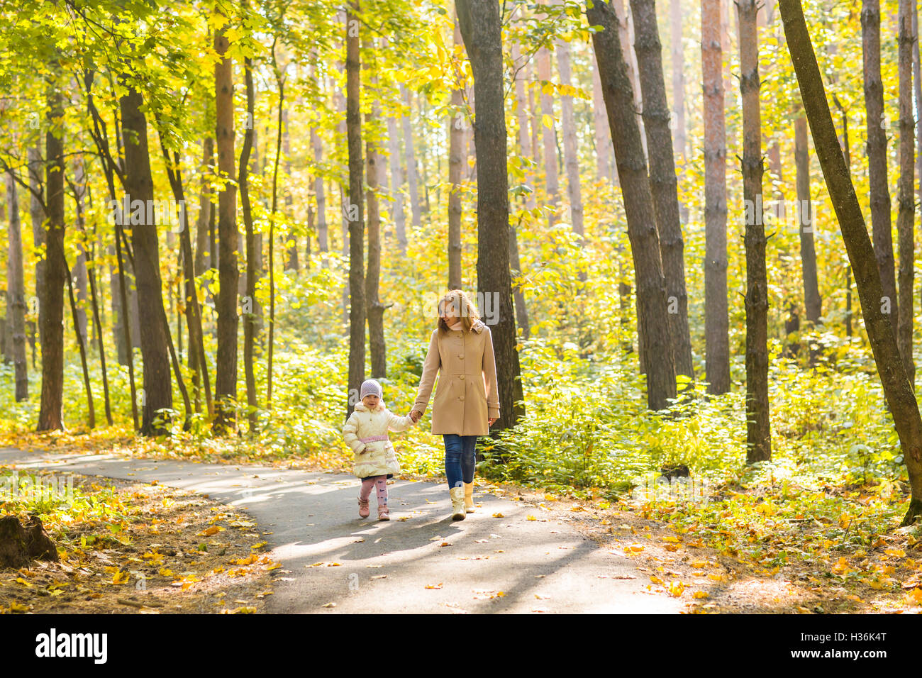 Mother and daughter walk in the autumn park Stock Photo - Alamy