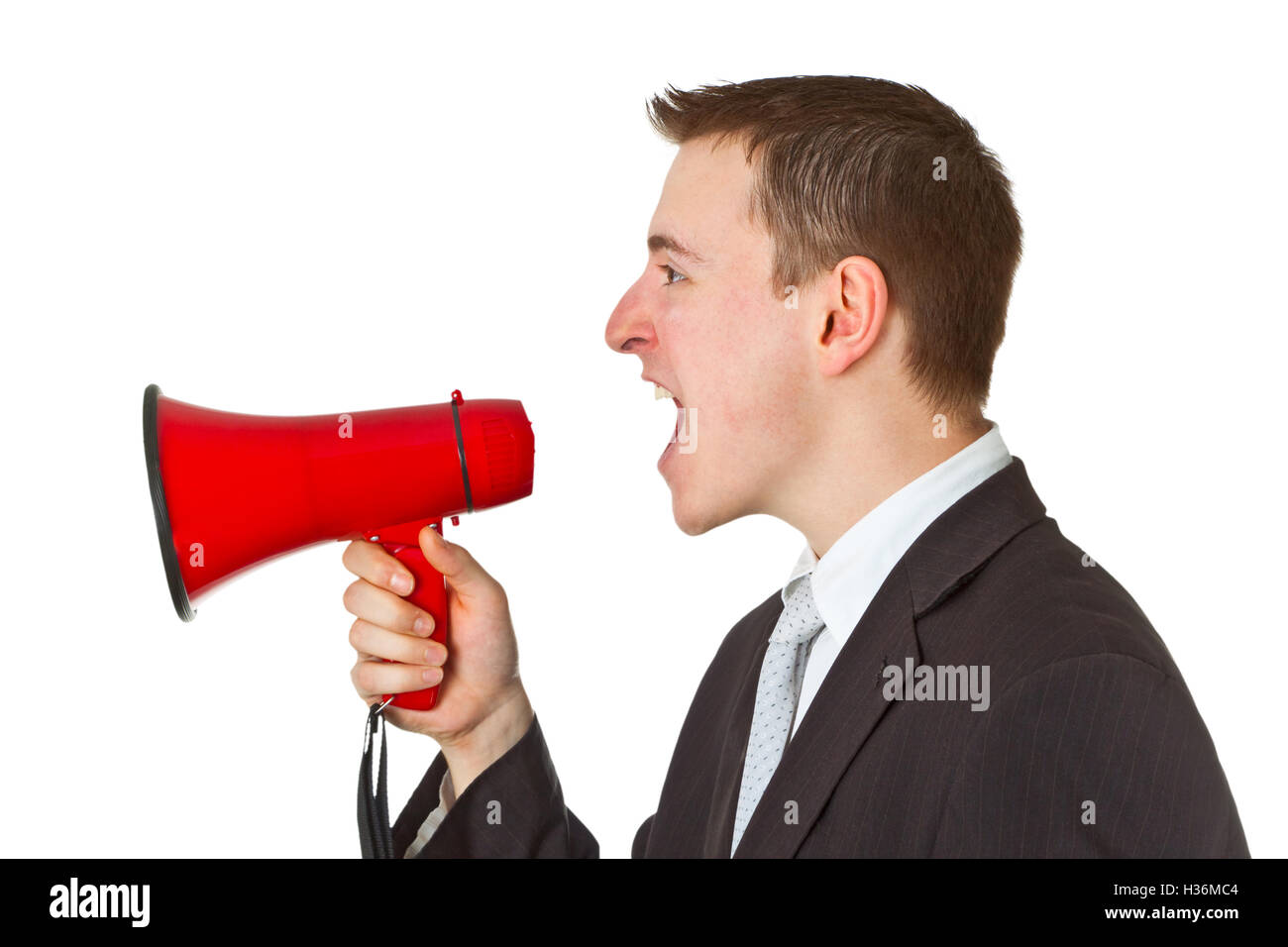 Businessman yelling through a megaphone isolated on white background ...