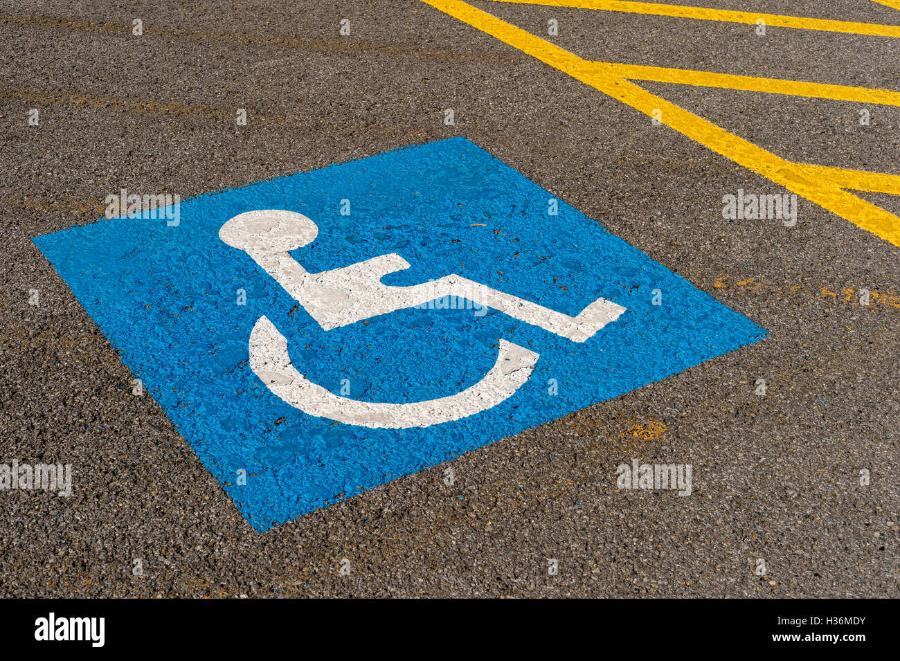 disabled blue parking sign painted on dark asphalt in Canada Stock ...