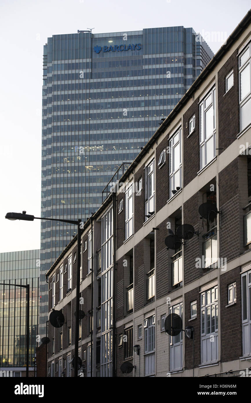 A Tower Hamlets estate is pictured with Barclays tower of Canary Wharf ...