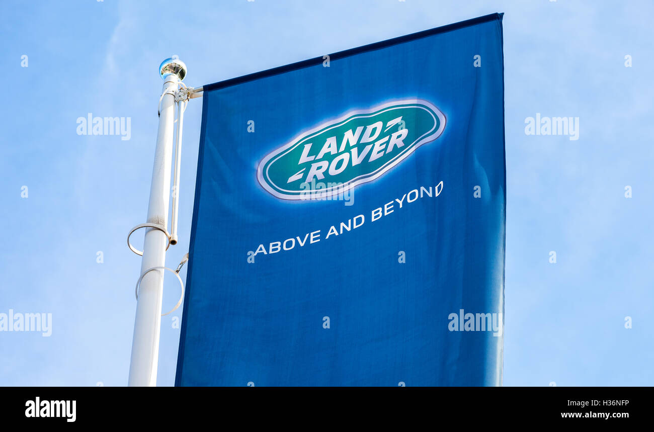 Official dealership flags of Land Rover against the blue sky background ...