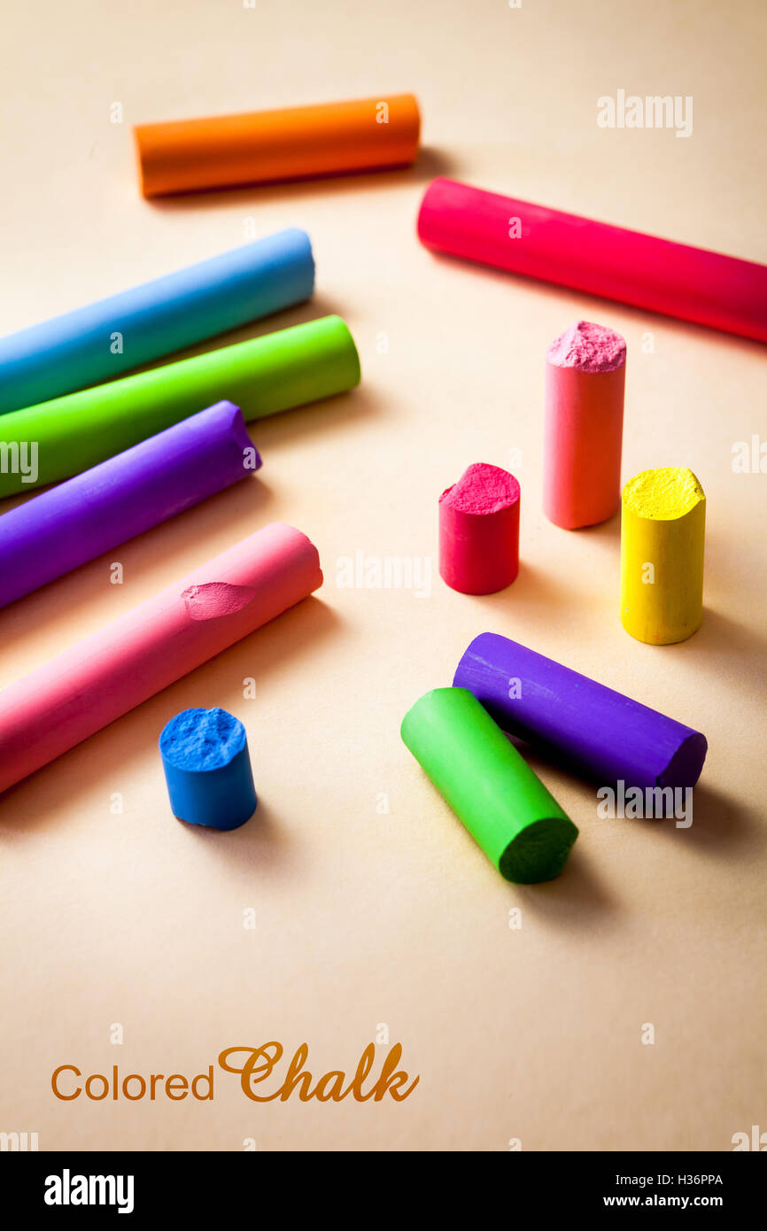 Colored chalk in variety of colors on a beige paper background Stock ...
