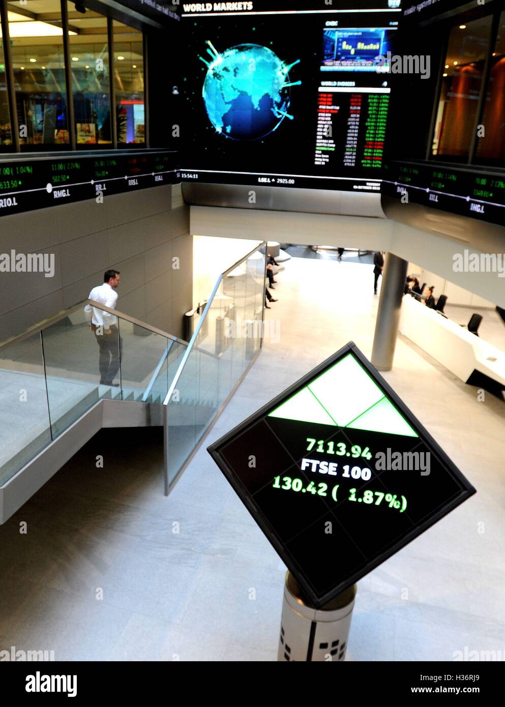 Electronic ticker tape shows the FTSE 100 (in green) inside the London ...