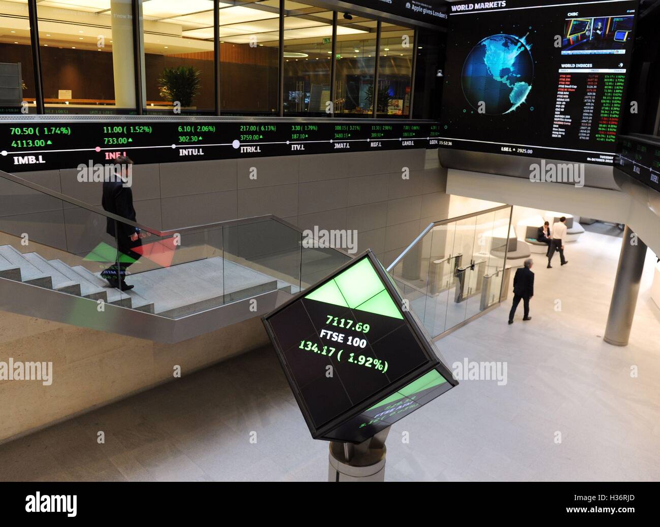 Electronic ticker tape shows the FTSE 100 (in green) inside the London ...