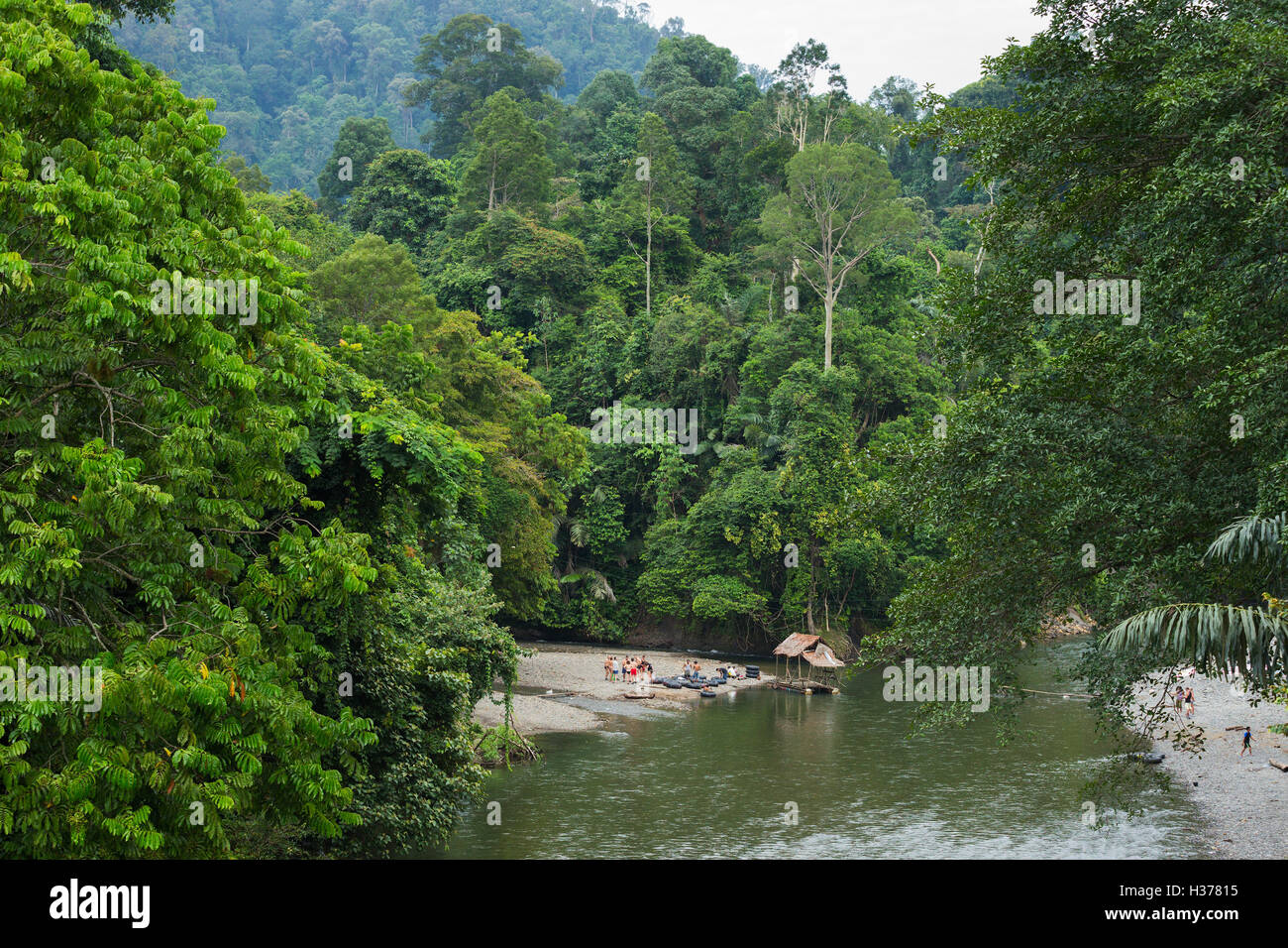 Looking down at the Batang river ferry, as a group of tourists get ...