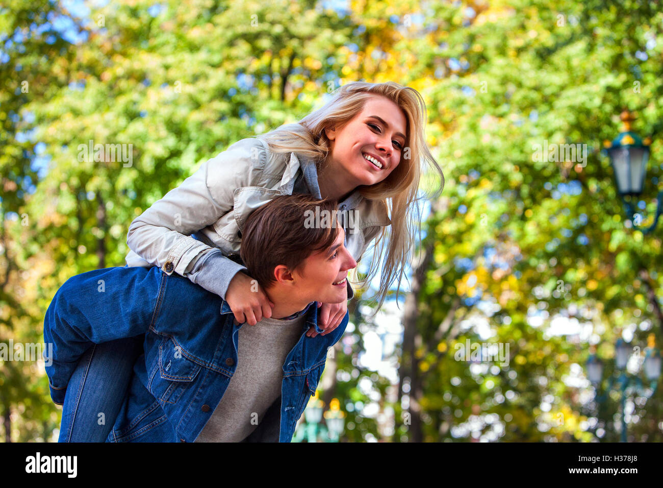 Young couple hugging and flirting in park Stock Photo - Alamy