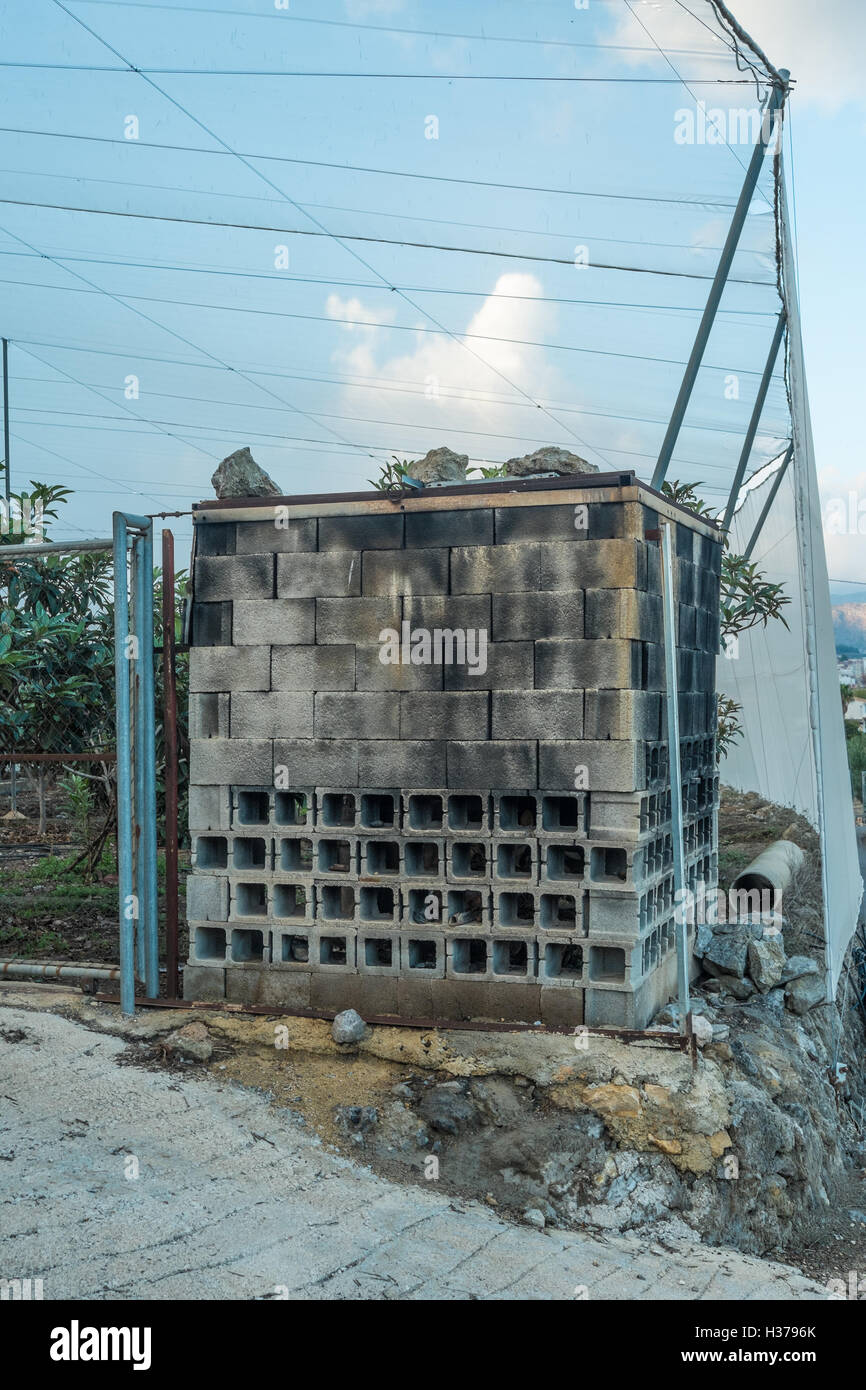 Concrete structure in a field used as burner for agricultural pruning ...