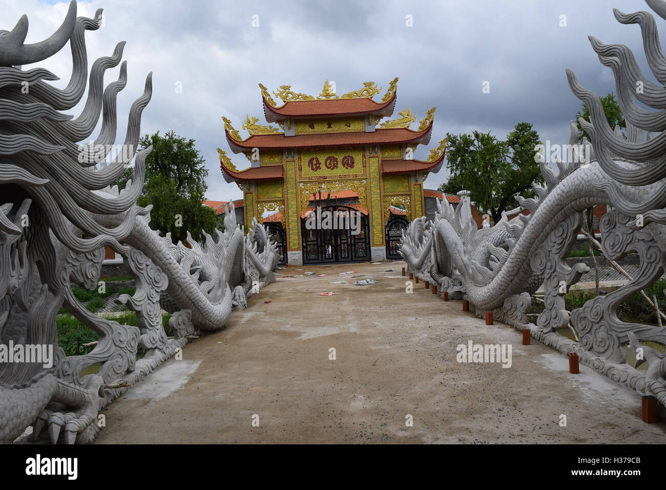 golden temple gate with two dragon on the sides in Ho Chi Minh city ...