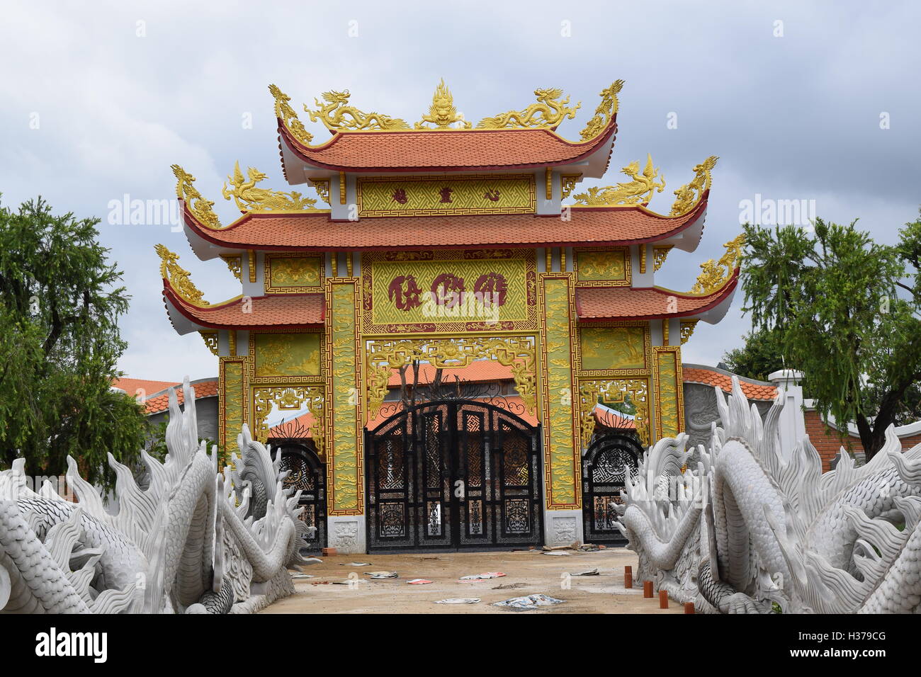 golden temple gate with two dragon on the sides in Ho Chi Minh city ...