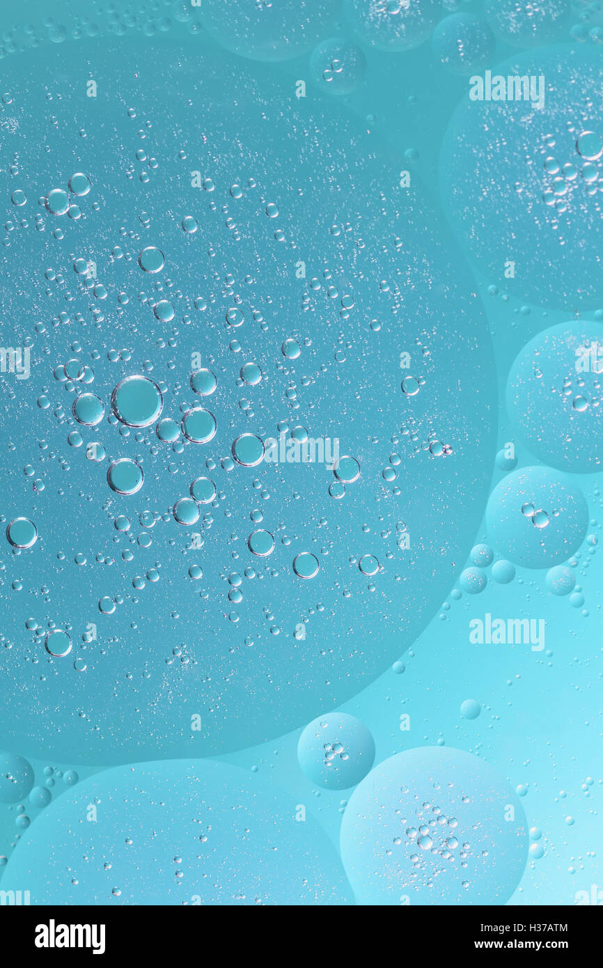 Abstract of oil droplet in water. All is in a light blue color Stock ...