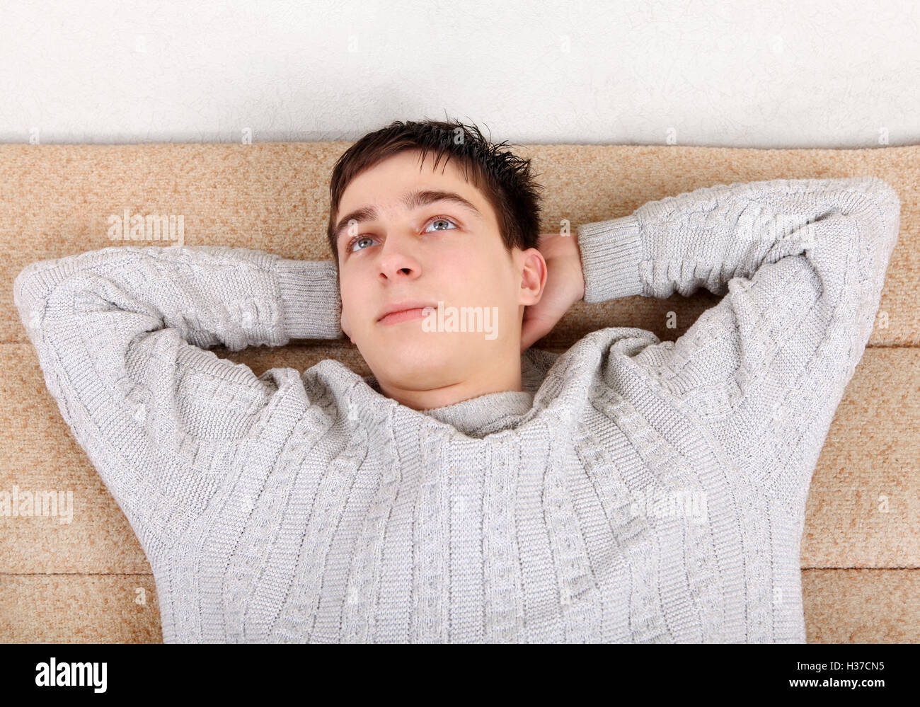 Teenager resting on Sofa Stock Photo - Alamy