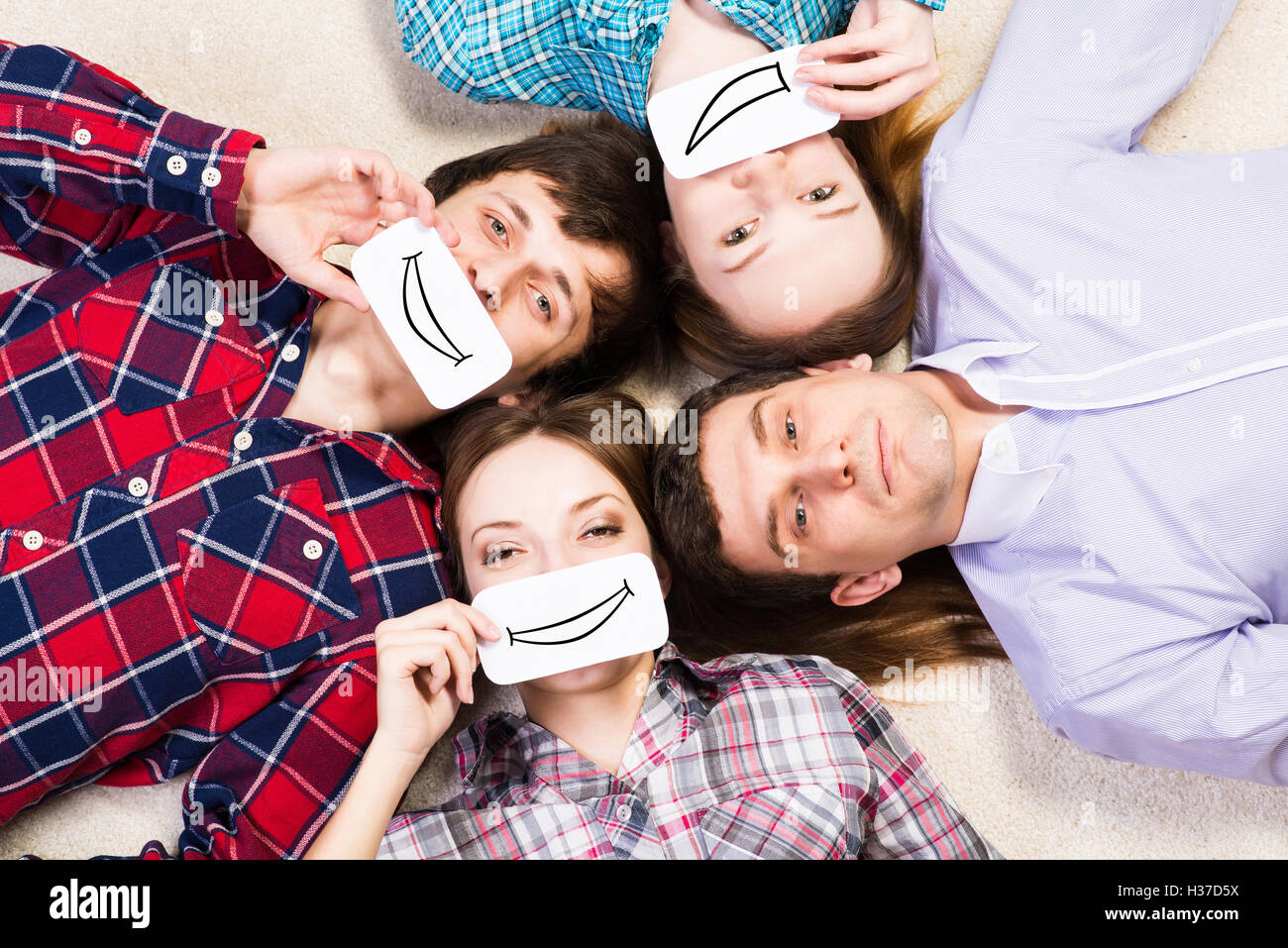 four young men lie together Stock Photo - Alamy