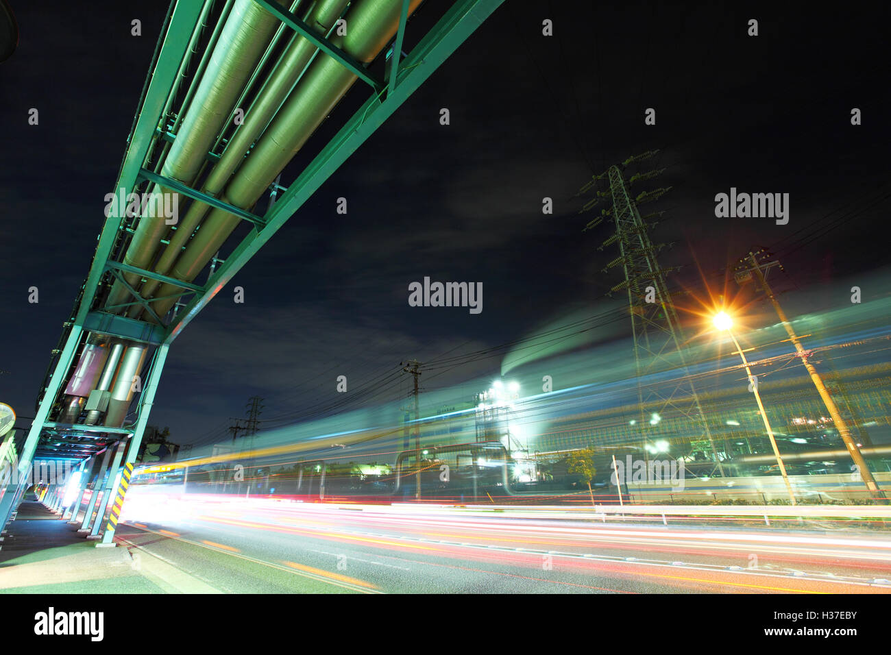 Industrial factory with traffic trail at night Stock Photo - Alamy