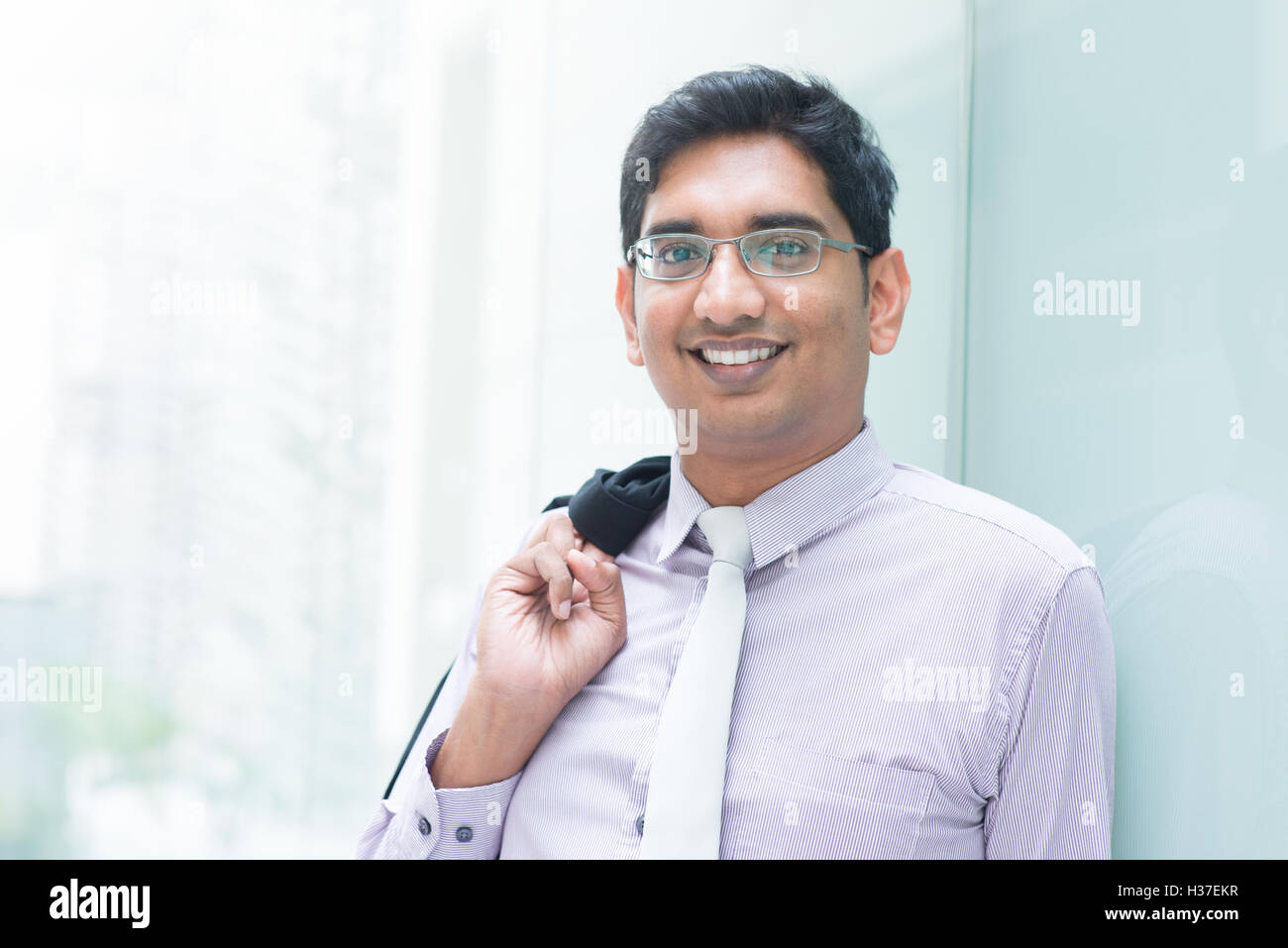 Indian business man leaning on modern building Stock Photo - Alamy