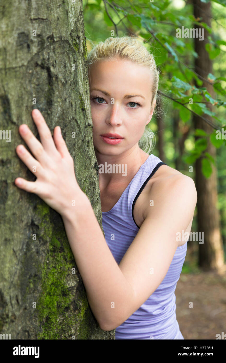Young woman hugging a tree Stock Photo - Alamy