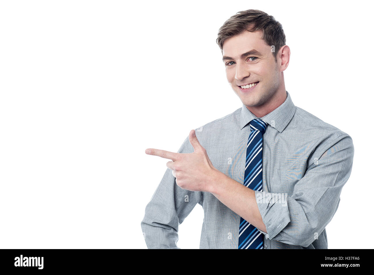 Cheerful young man pointing at something Stock Photo - Alamy