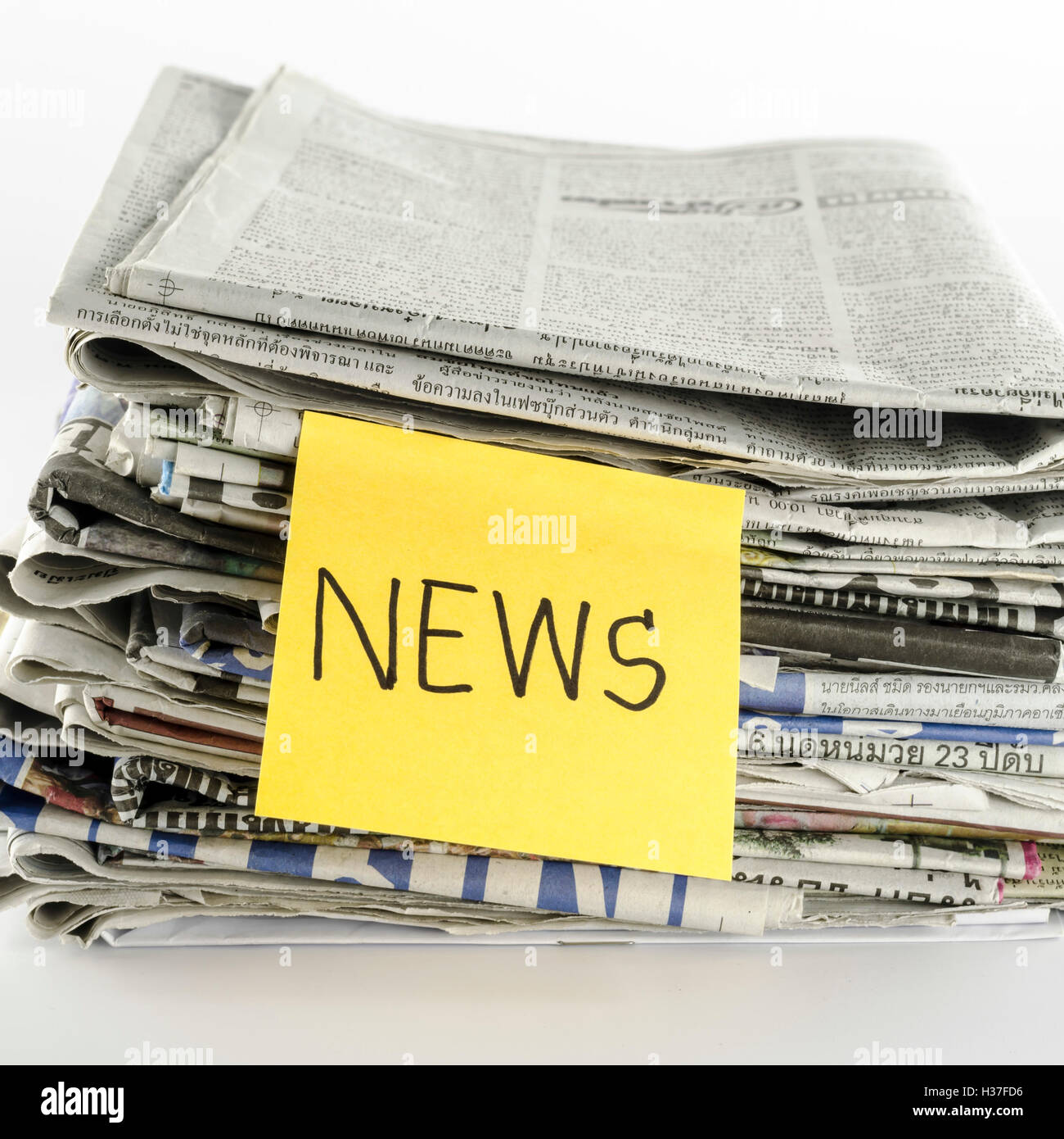 stack of newspaper with post it write news word Stock Photo - Alamy