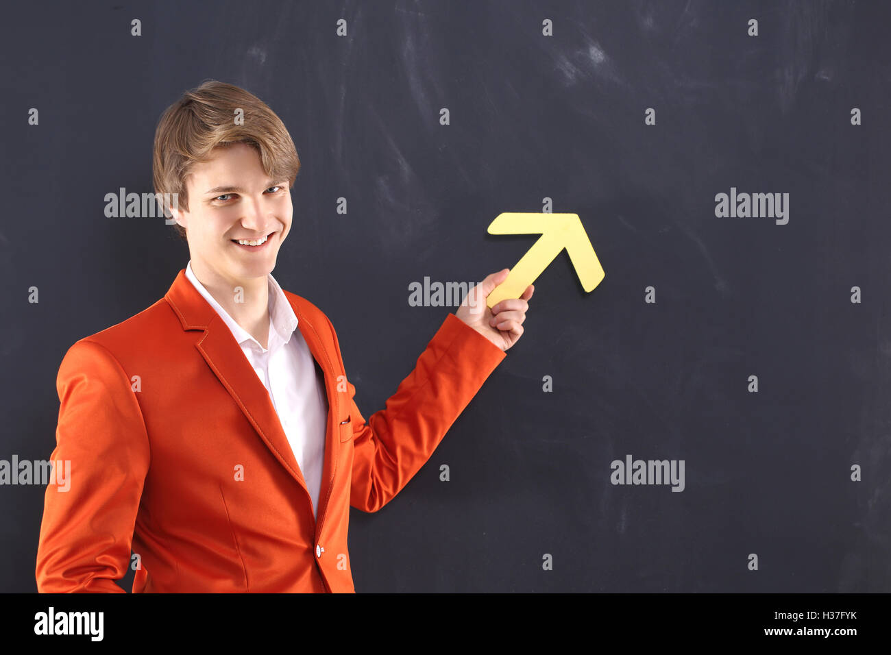 Happy man pointing at the black board Stock Photo - Alamy