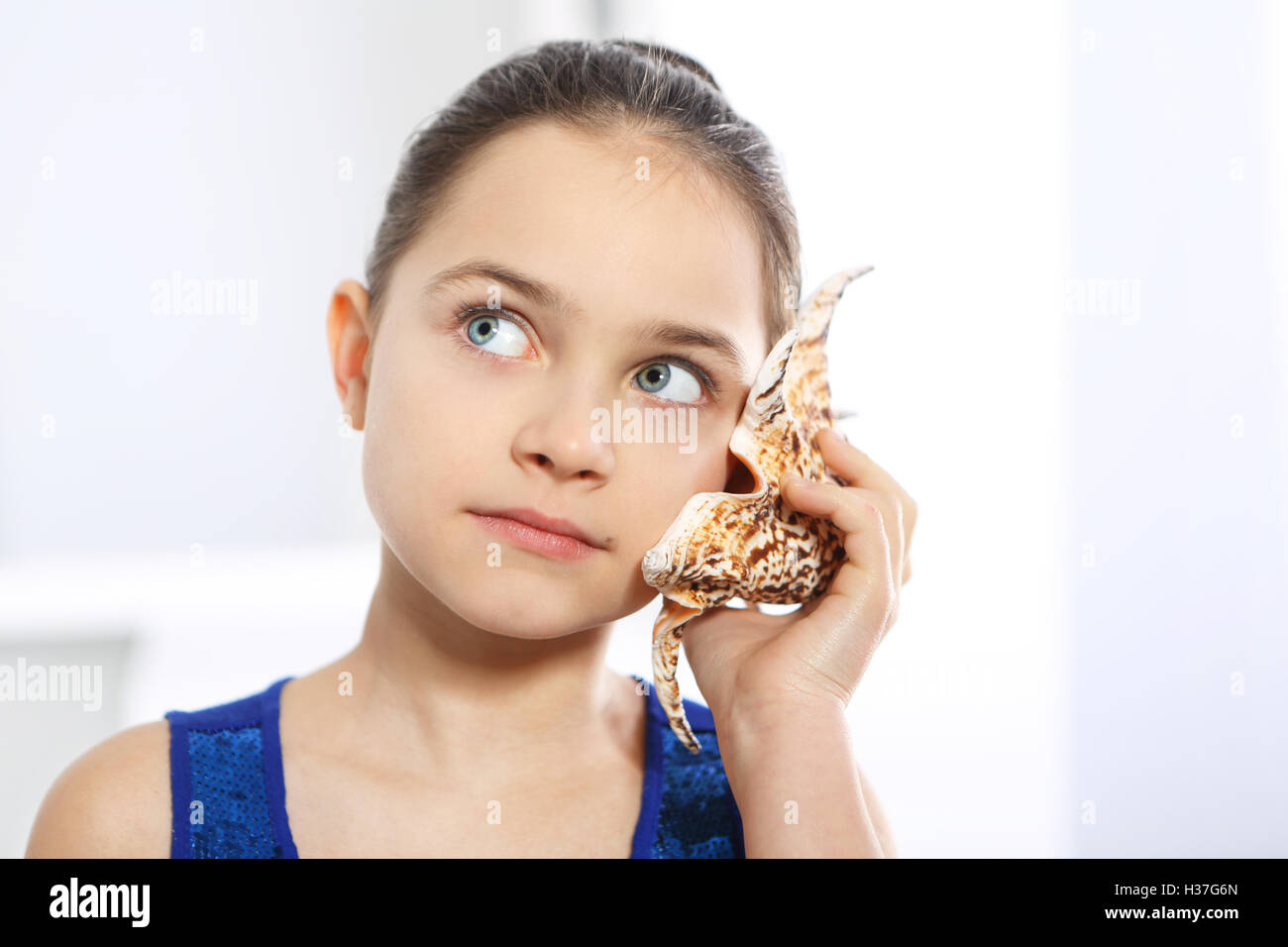 Girl with shell Stock Photo - Alamy