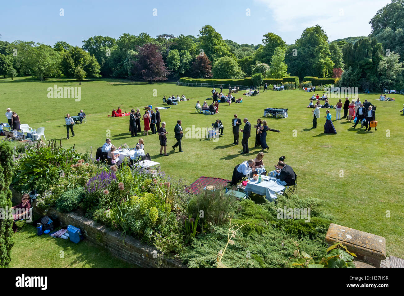 During a performance interval, opera-goers enjoy a picnic on the lawns ...