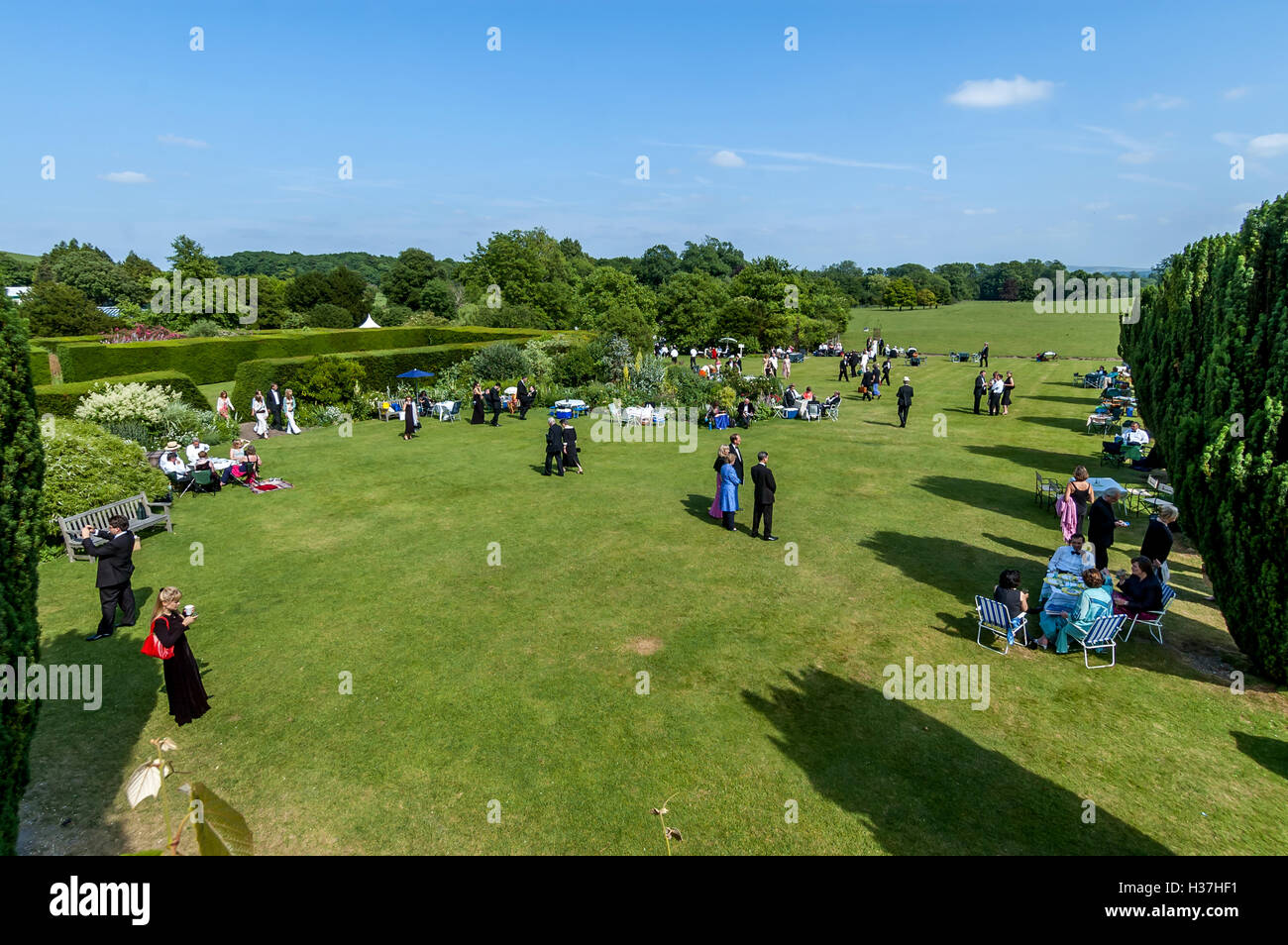 During a performance interval, opera-goers enjoy a picnic on the lawns ...