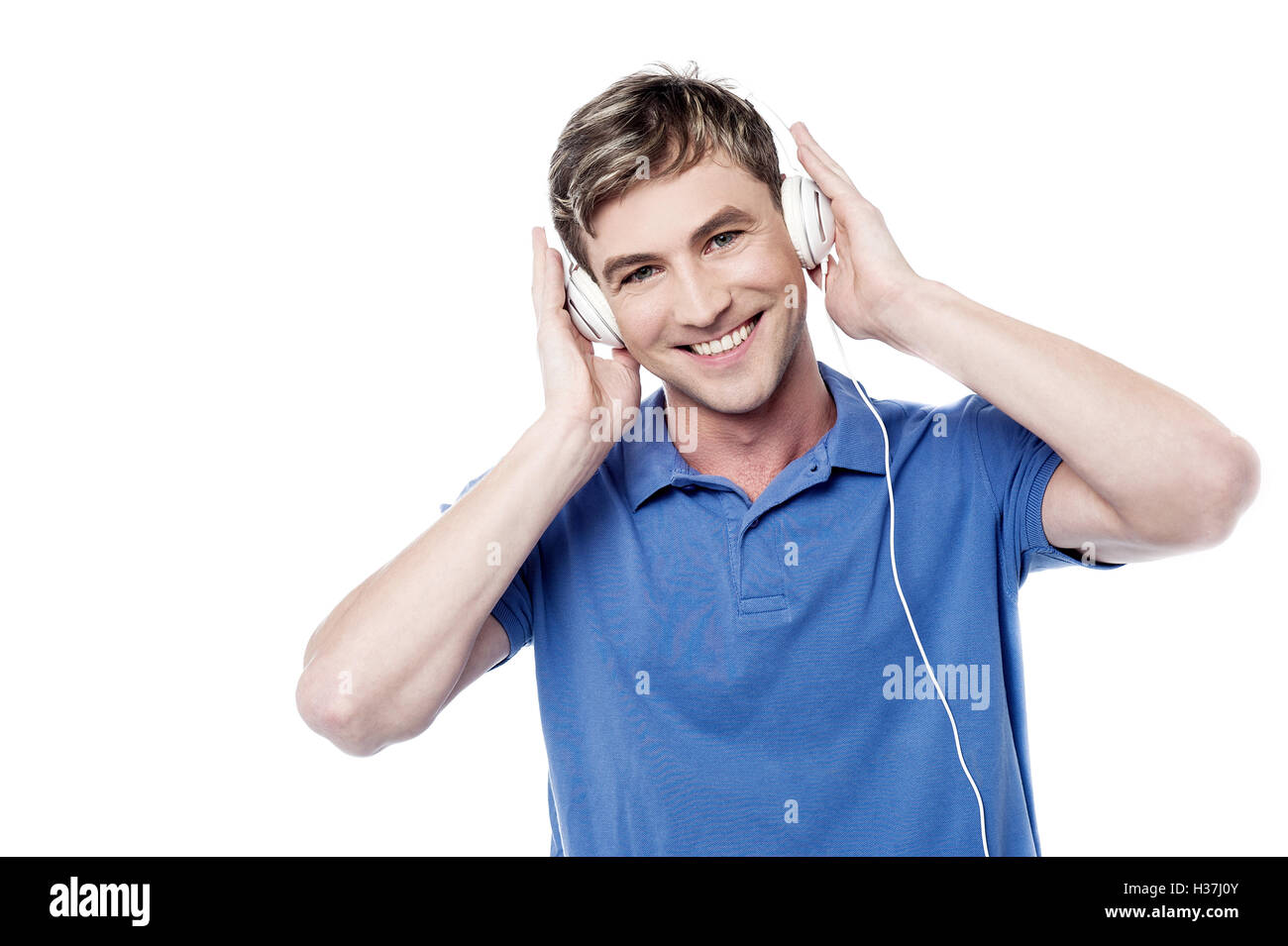 Cheerful young man enjoying music Stock Photo - Alamy