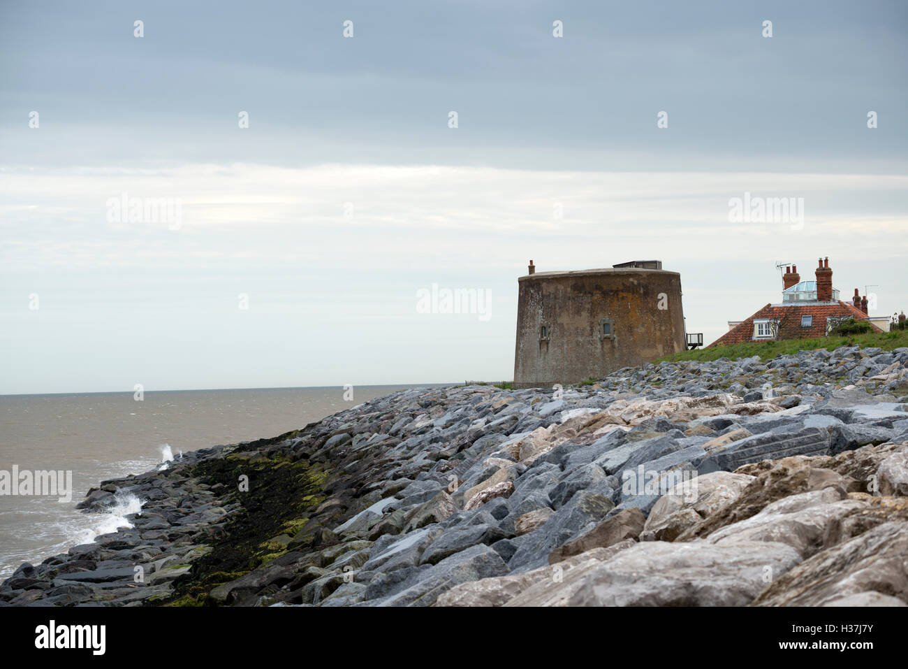 Martello Tower and house protected from coastal erosion by rock armour ...