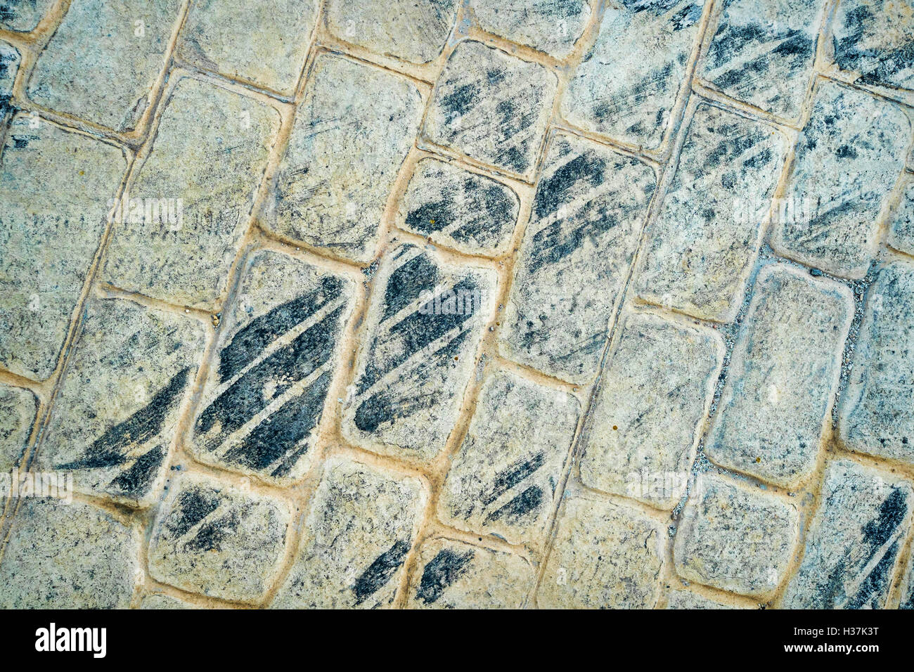Fresh tire marks on a cobblestone street Stock Photo - Alamy