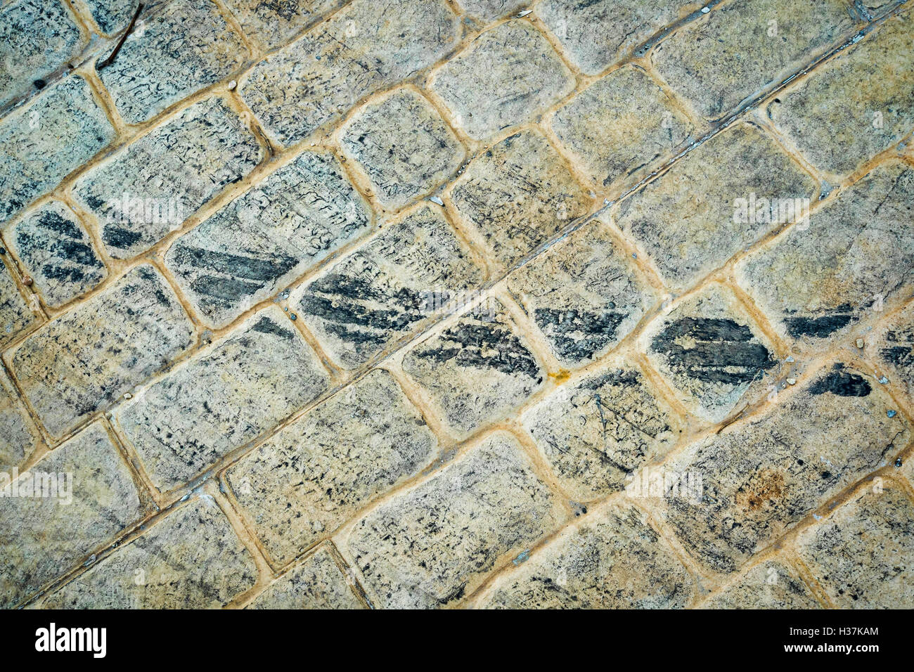 Fresh tire marks on a cobblestone street Stock Photo - Alamy