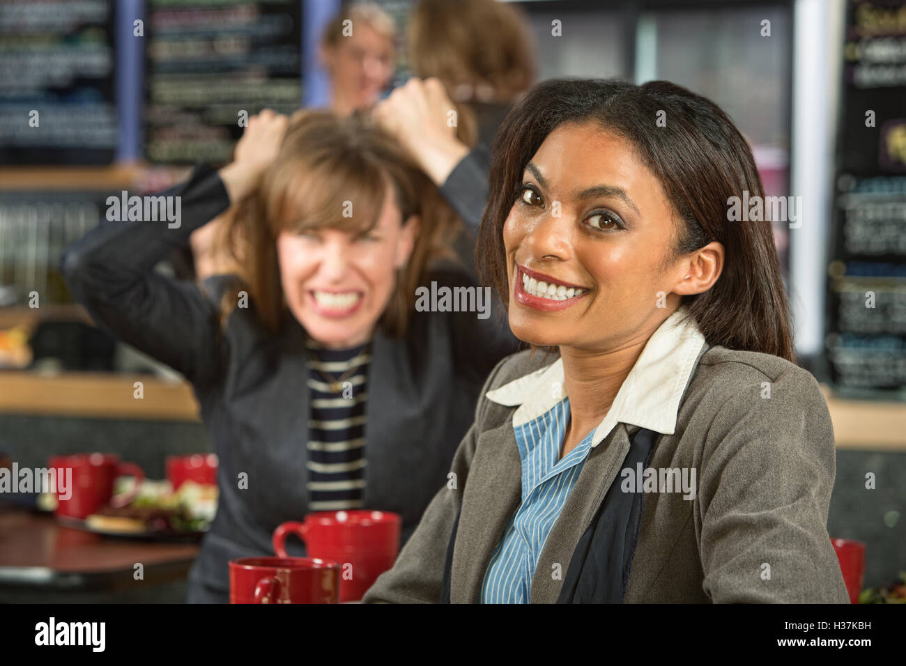 Woman with Frustrated Friend Stock Photo - Alamy