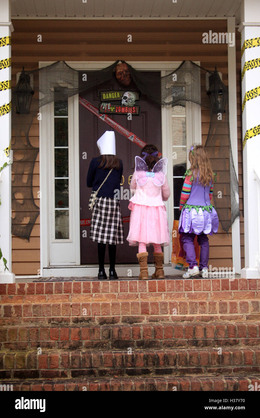 Children going trick-or-treating on Halloween Stock Photo - Alamy