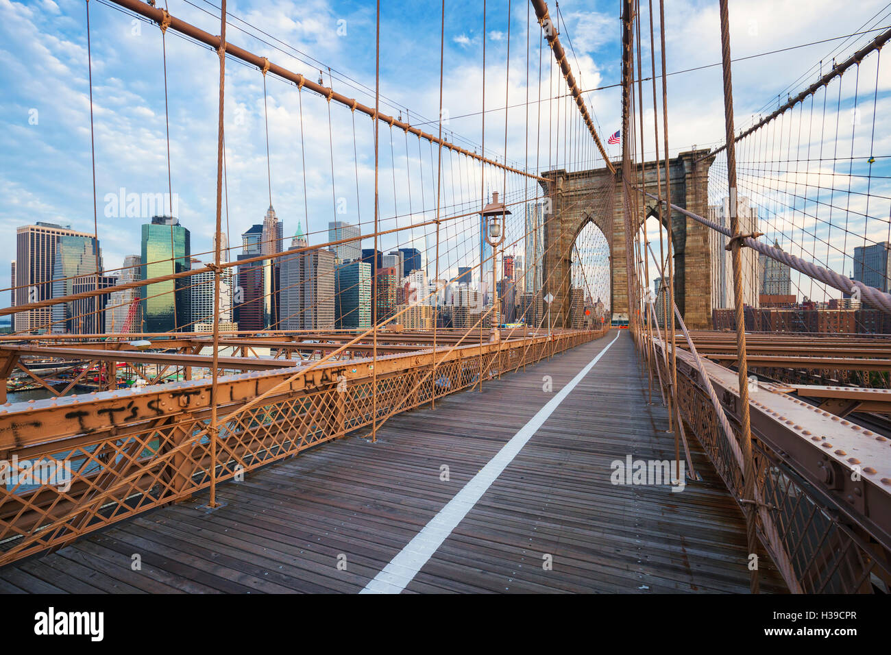 New York City Brooklyn Bridge in Manhattan with skyscrapers and city skyline over Hudson River ...