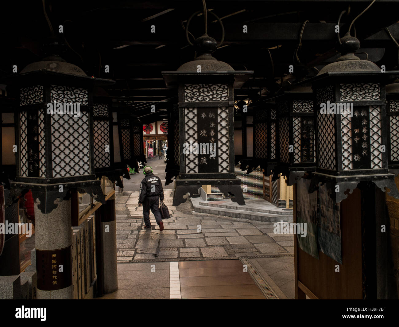 man walking past ornate lanterns, Hozenji temple, osaka, Japan Stock ...