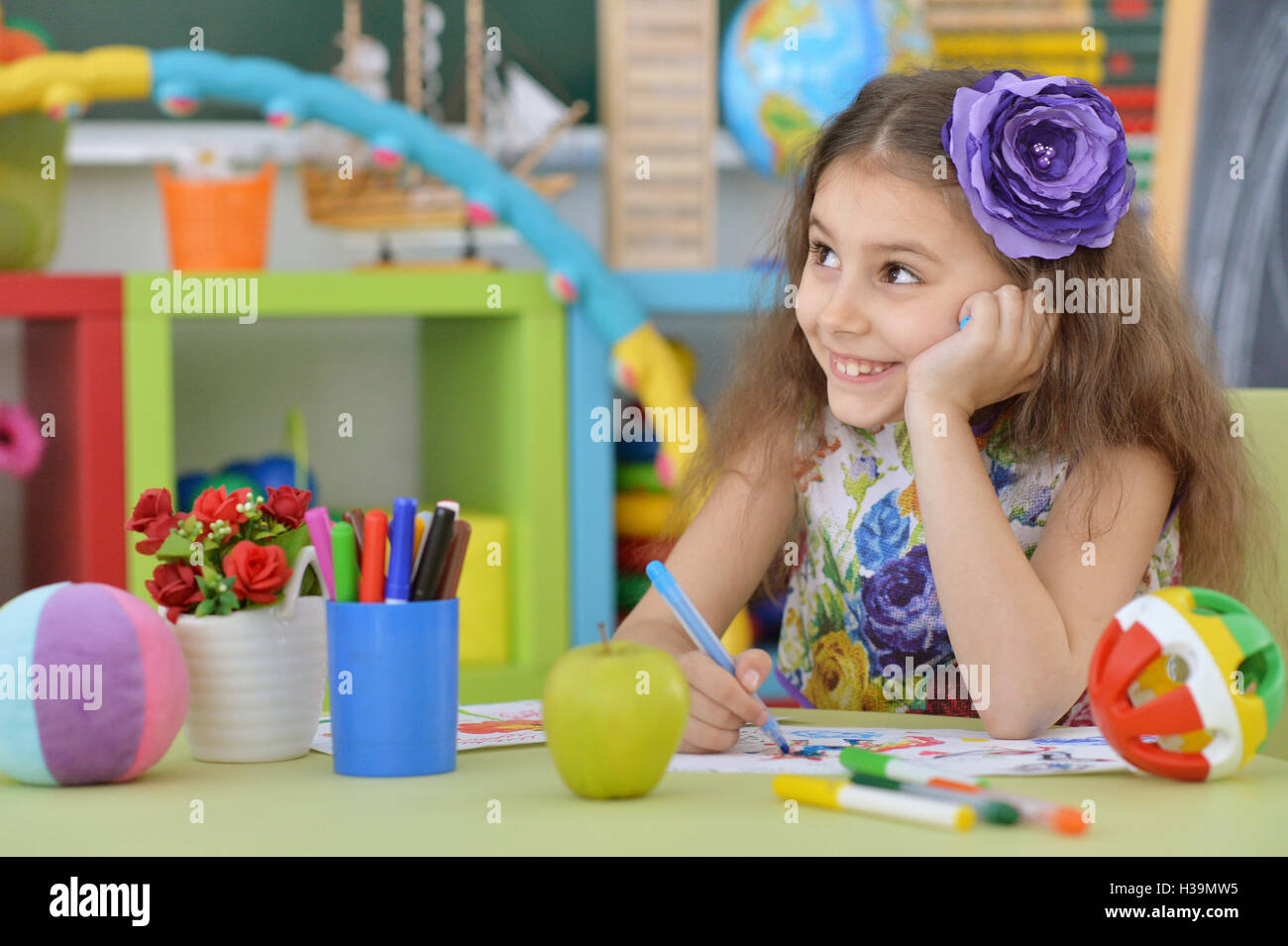 Little girl drawing at class Stock Photo - Alamy