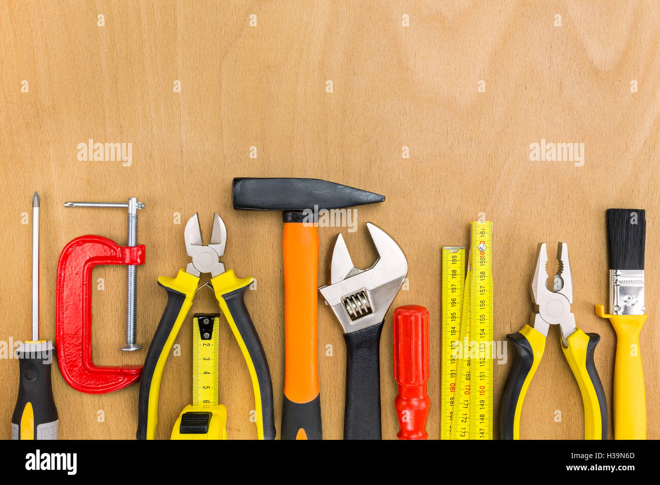 Work tools lined up in a straight line on wooden background Stock Photo ...