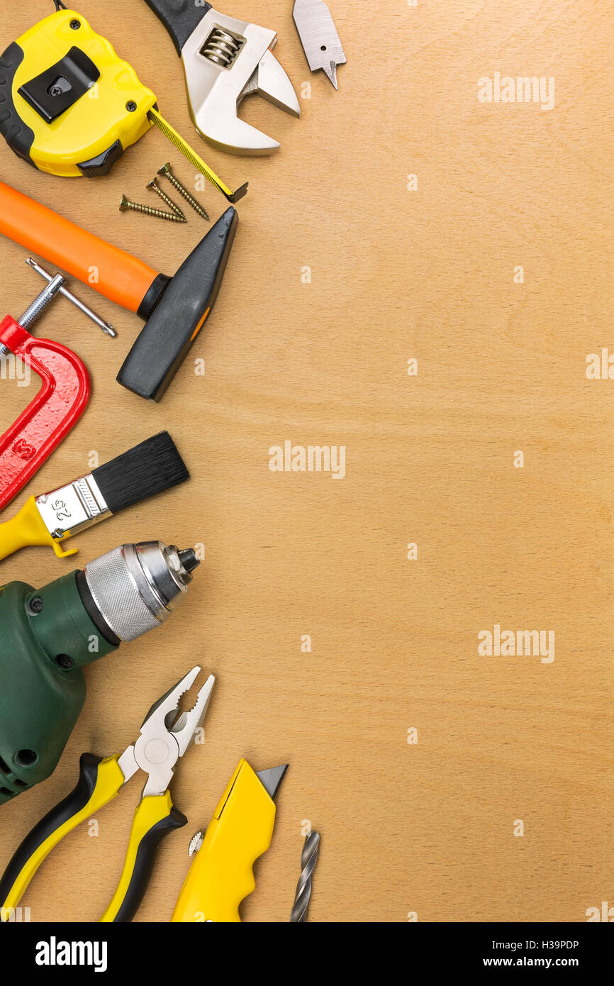 Assorted construction work tools on wooden background Stock Photo - Alamy