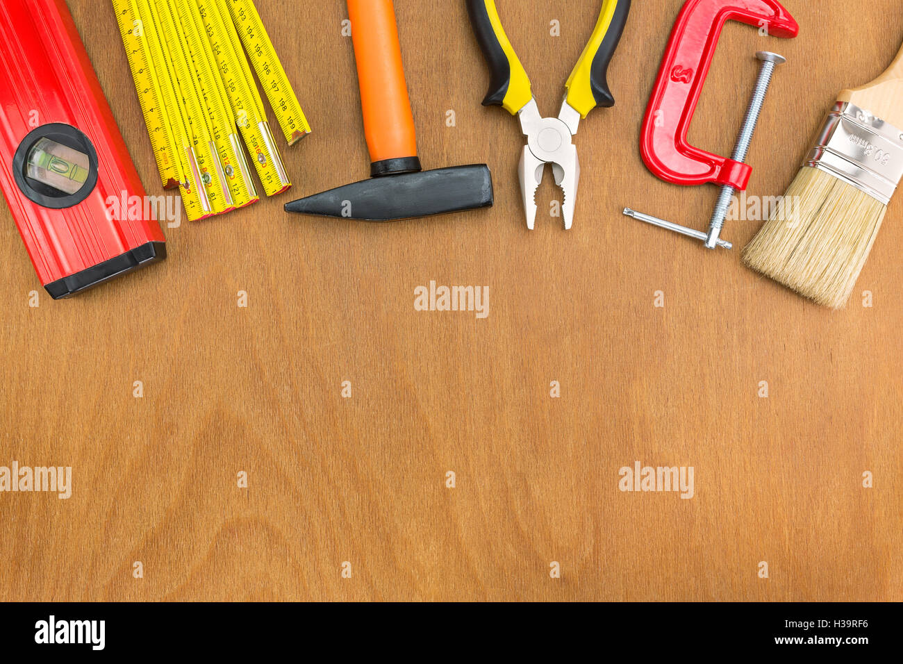 Set of work tools on wood panel background Stock Photo - Alamy
