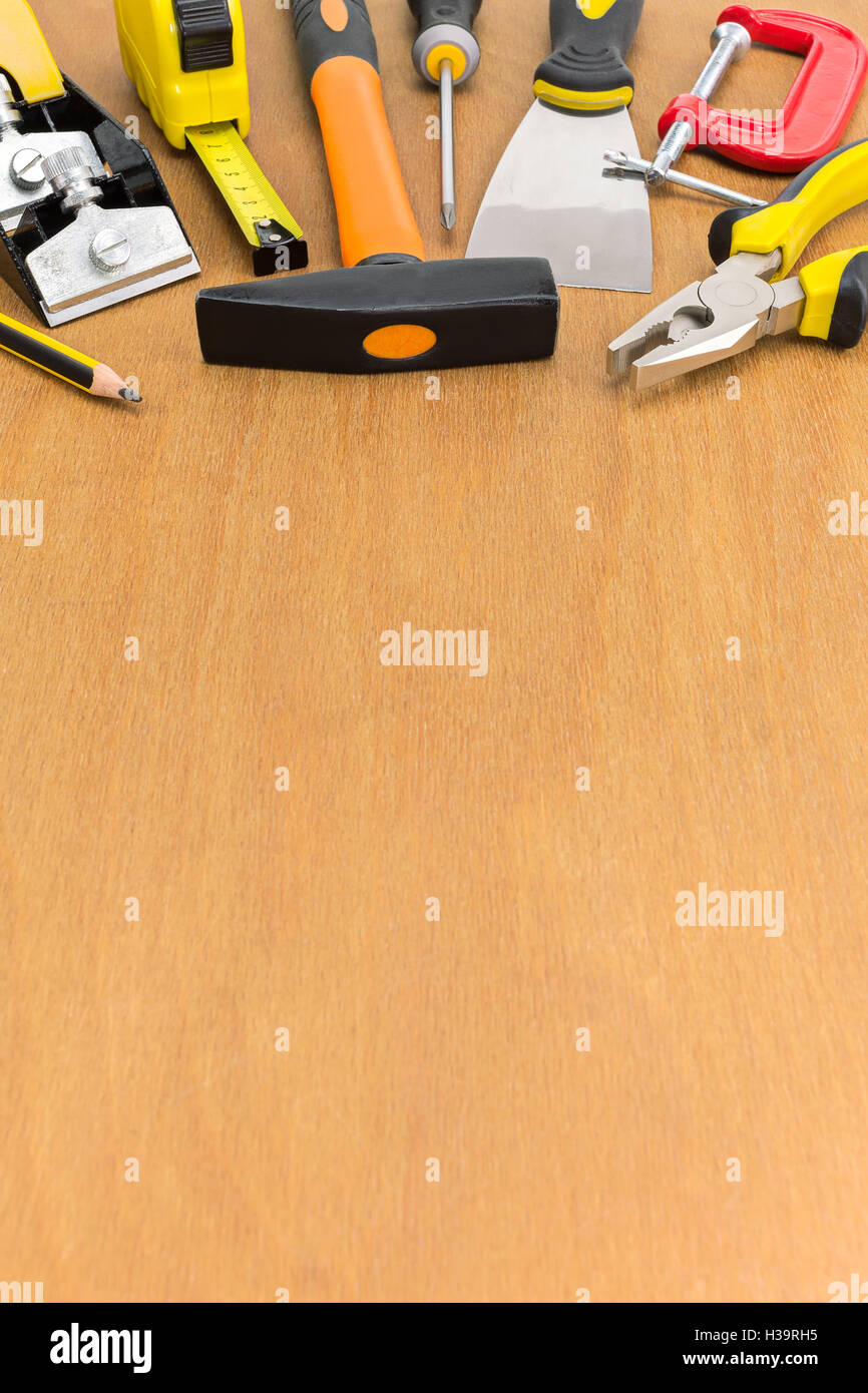Assorted construction work tools on wooden background Stock Photo - Alamy