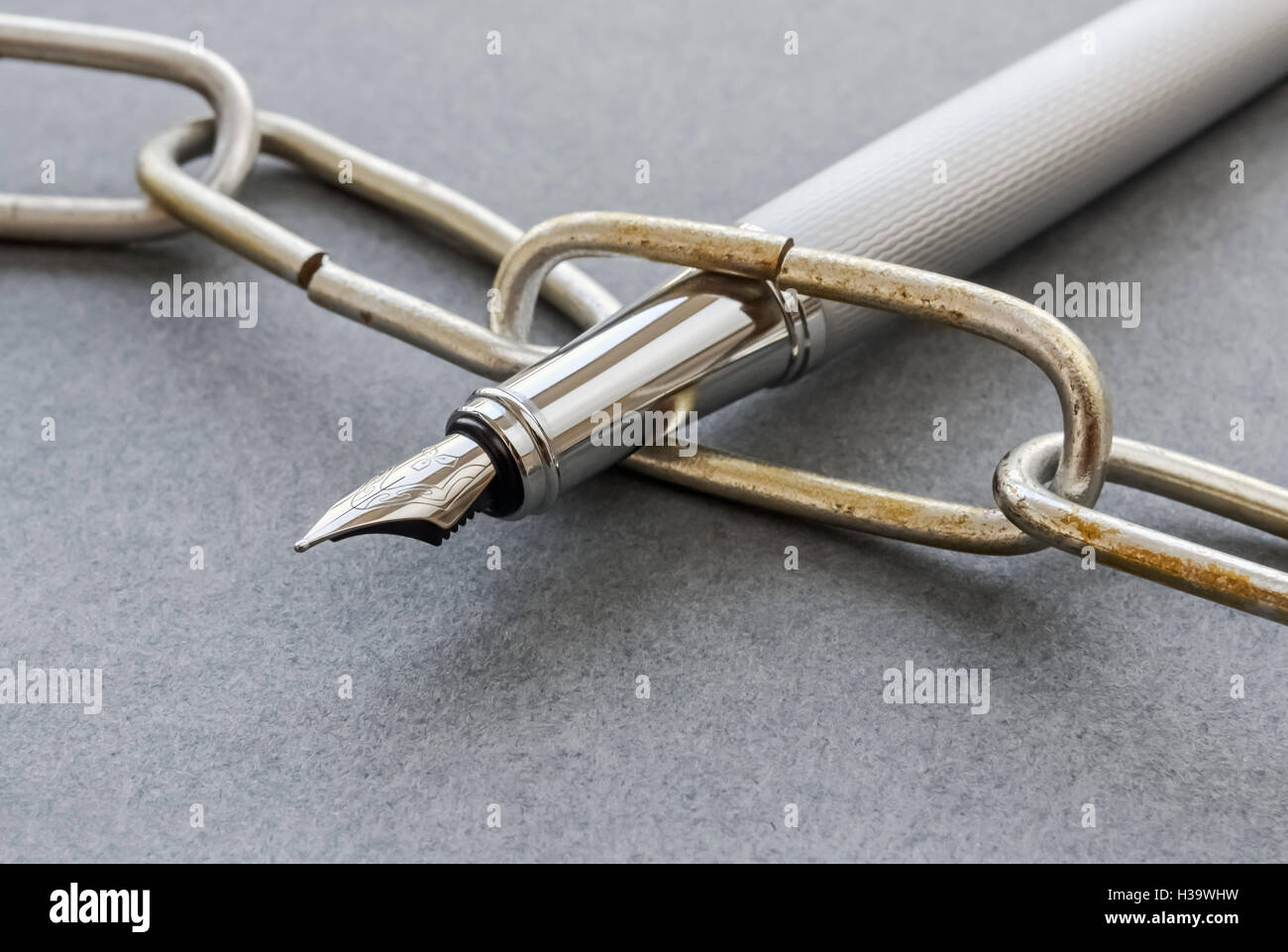 Closeup of a silver fountain pen and a chain Stock Photo - Alamy