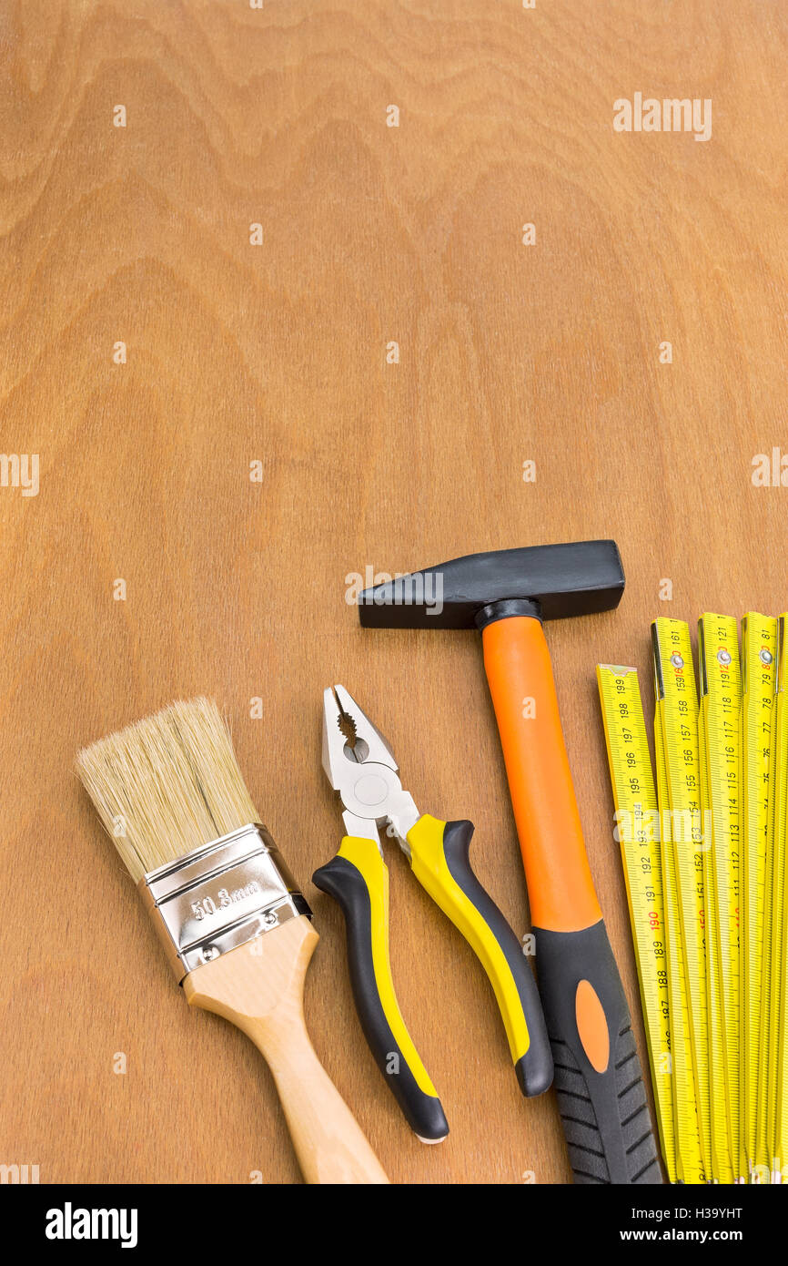 Set of work tools on wood panel background Stock Photo - Alamy