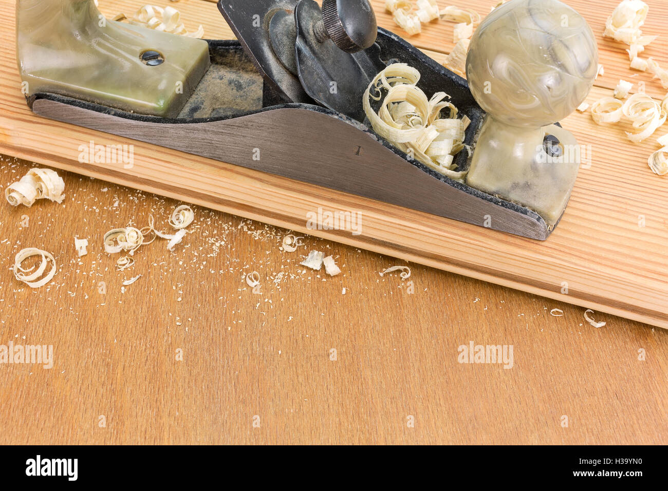 Carpenter's plane with shavings on a wooden planks Stock Photo - Alamy