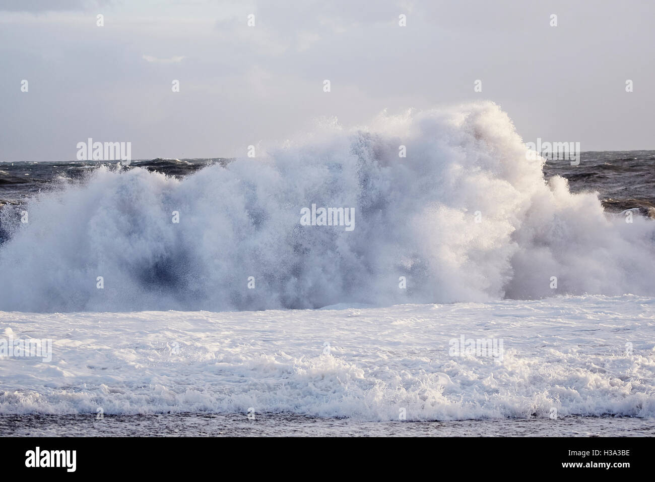 Ocean wave breaking on beach Stock Photo - Alamy