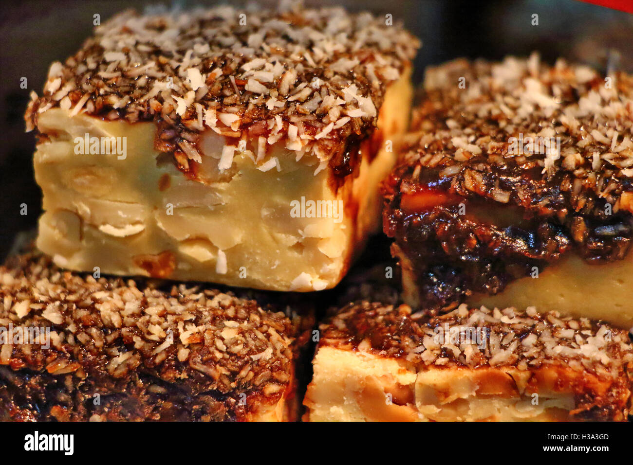 Eastern sweets, Black background, Pieces of cake, coconut flakes, nut ...